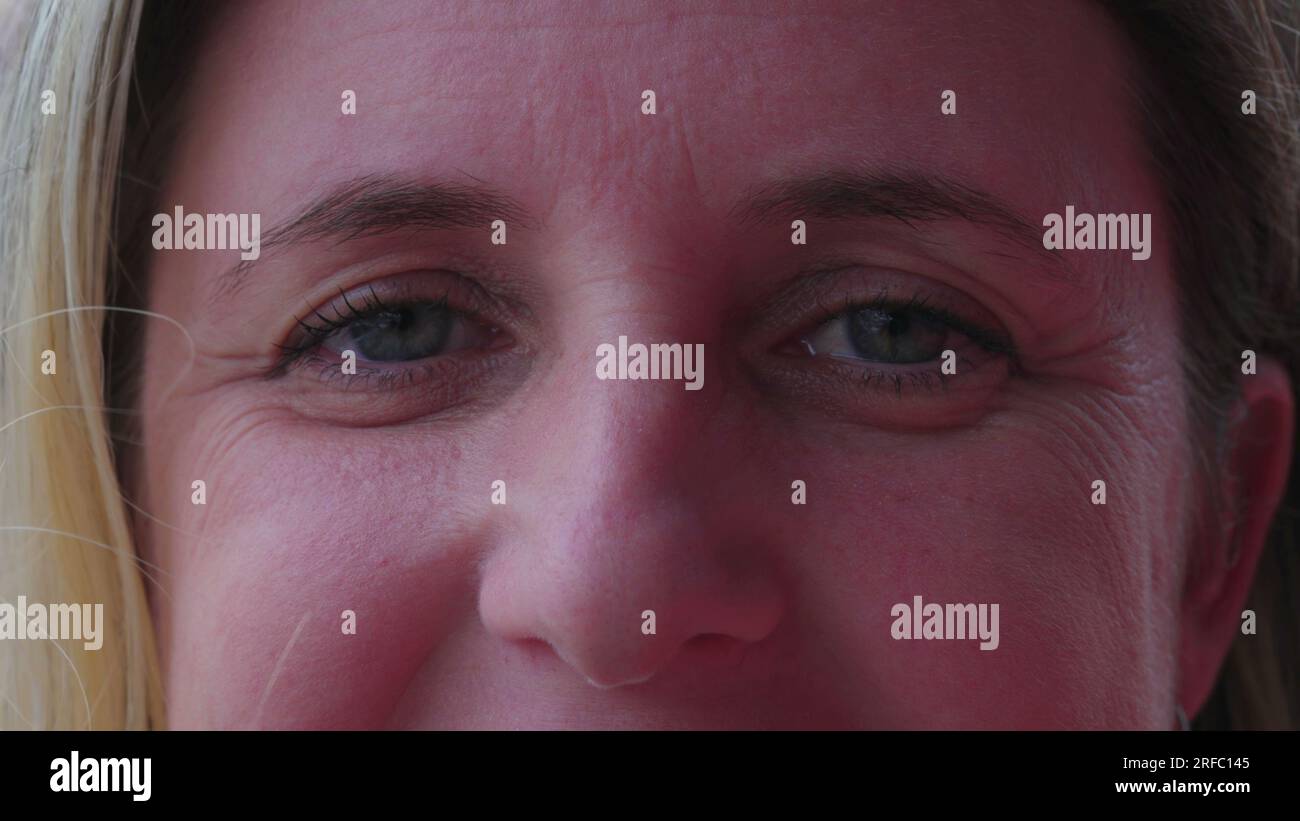 Macro close-up of a joyful middle-age woman smiling at camera. One ...