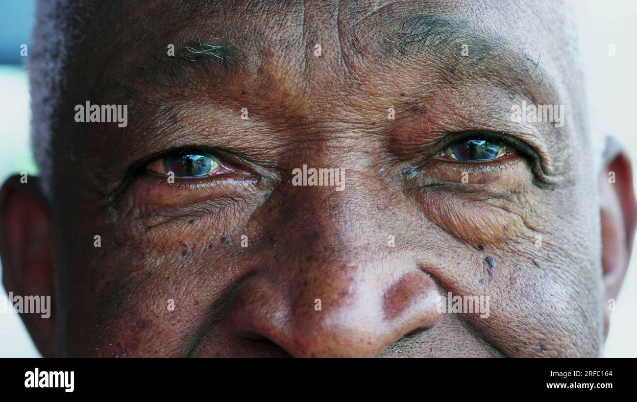 Macro tight close-up of an African American senior man with blue eyes ...
