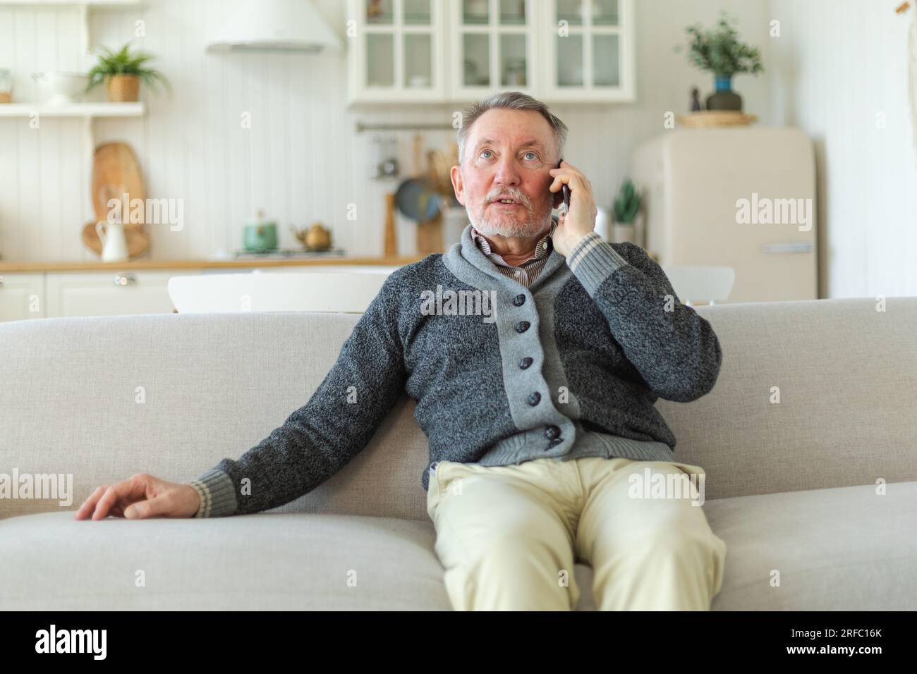 Happy middle aged senior man talking on smartphone with family friends ...