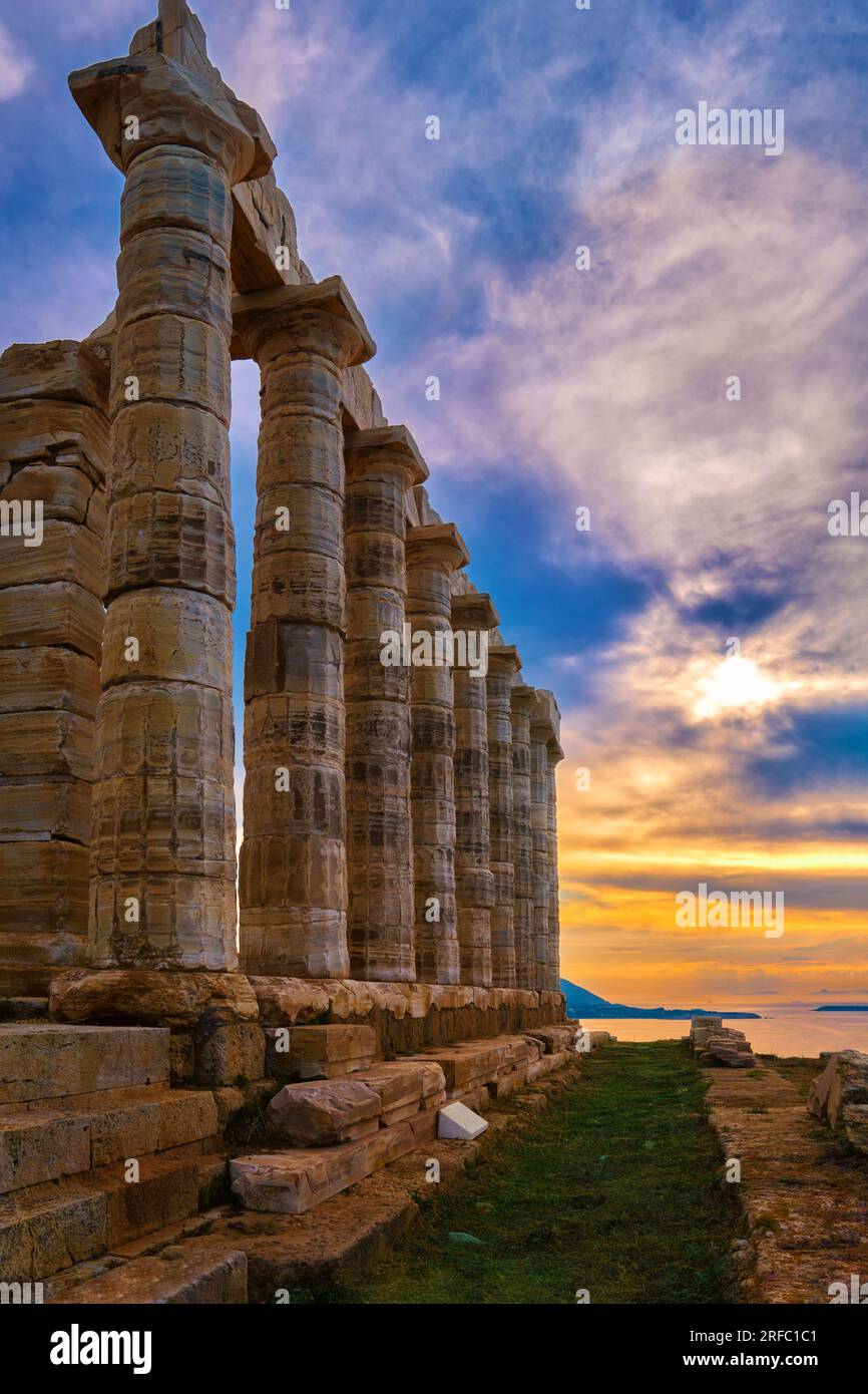 Sunset sky and ancient ruins of temple of Poseidon, Sounion, Greece ...