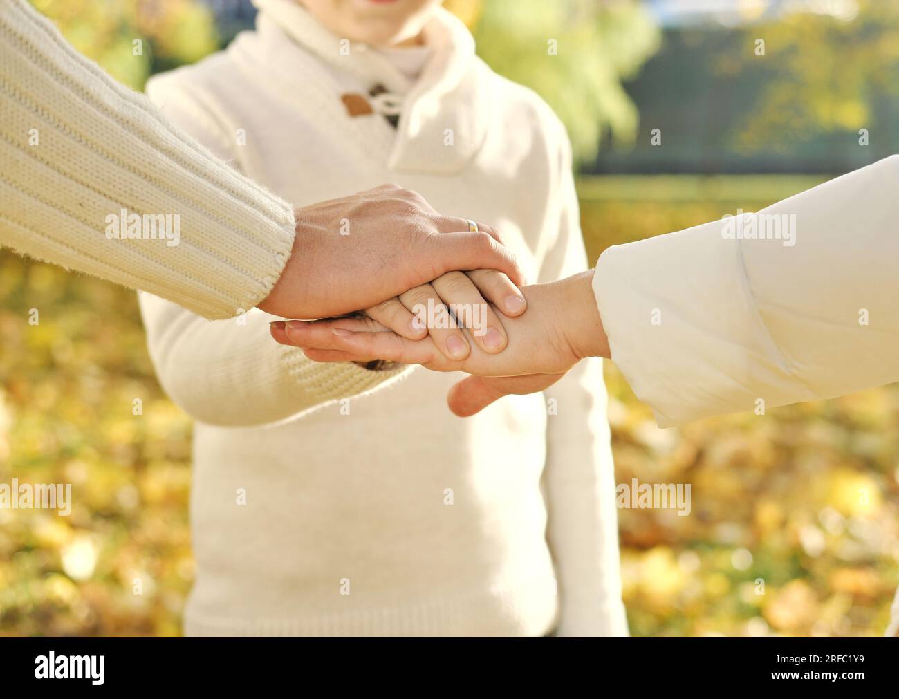 Close up of three Caucasian person stack their palms. Father, mother ...