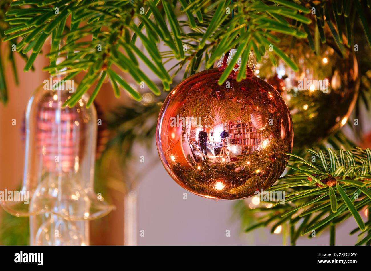 glossy glass sphere on a christmas tree with mirroring of a ...