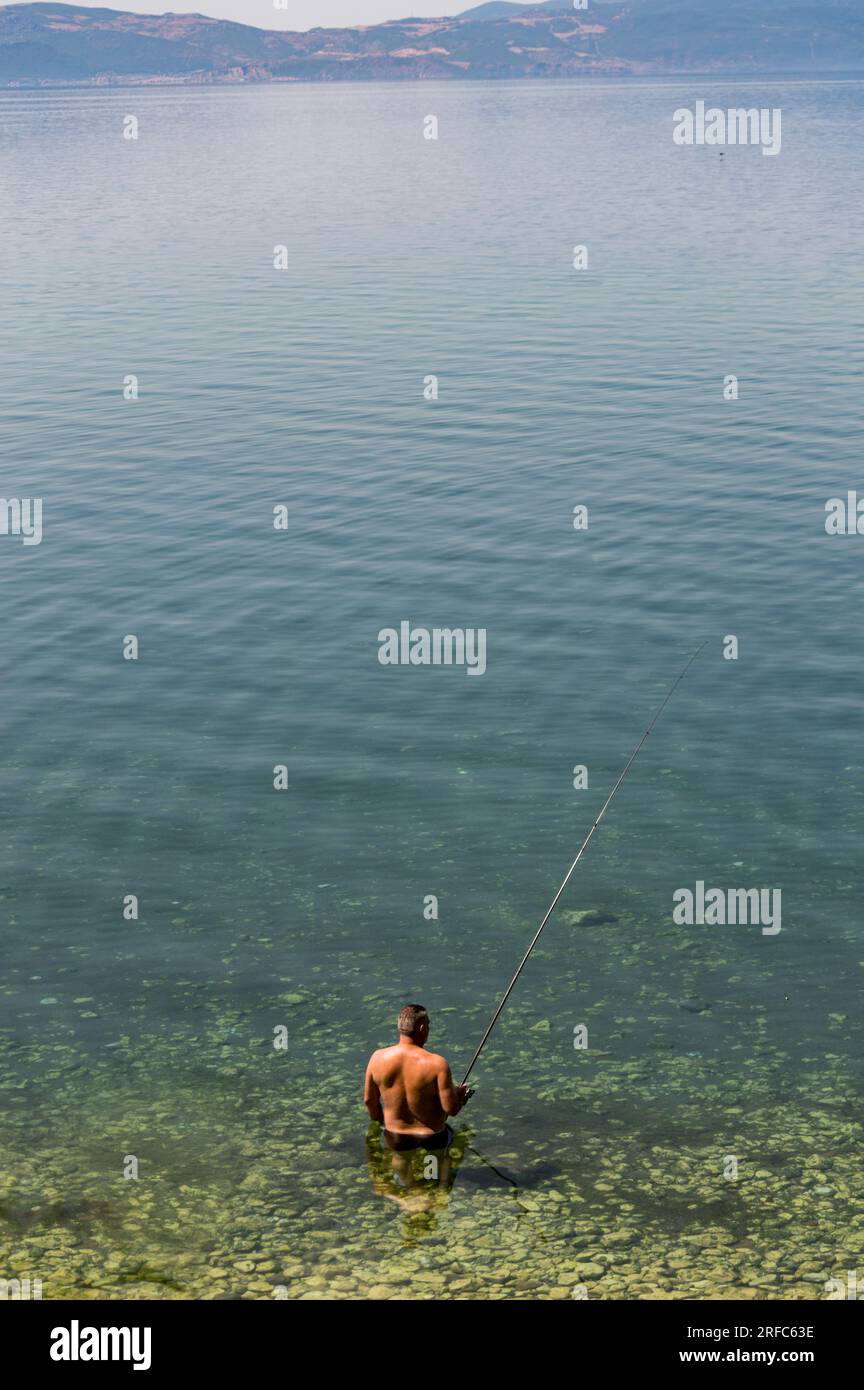 Lake Ohrid, FYR Macedonia - August 20th, 2014: Suntanned man fishing in ...