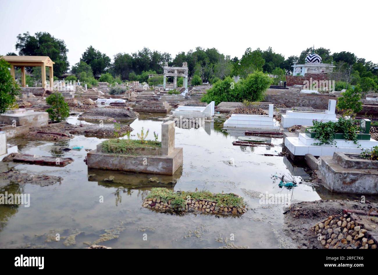 Hyderabad, Pakistan, August 2, 2023. The inundated graveyard of Tando ...