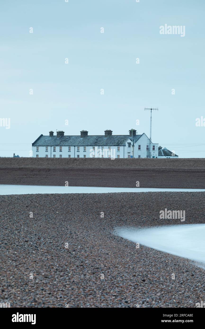 Coastguard Cottages framed by the curve of the beach, Shingle Street ...