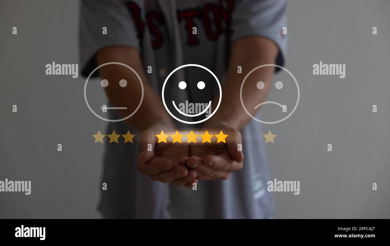 Hand touching and doing mark to select smiley face icon for evaluate ...