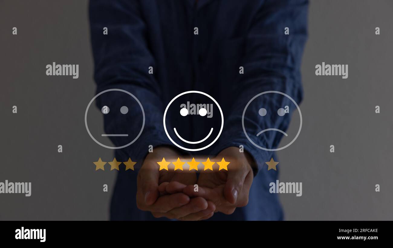 Hand touching and doing mark to select smiley face icon for evaluate ...