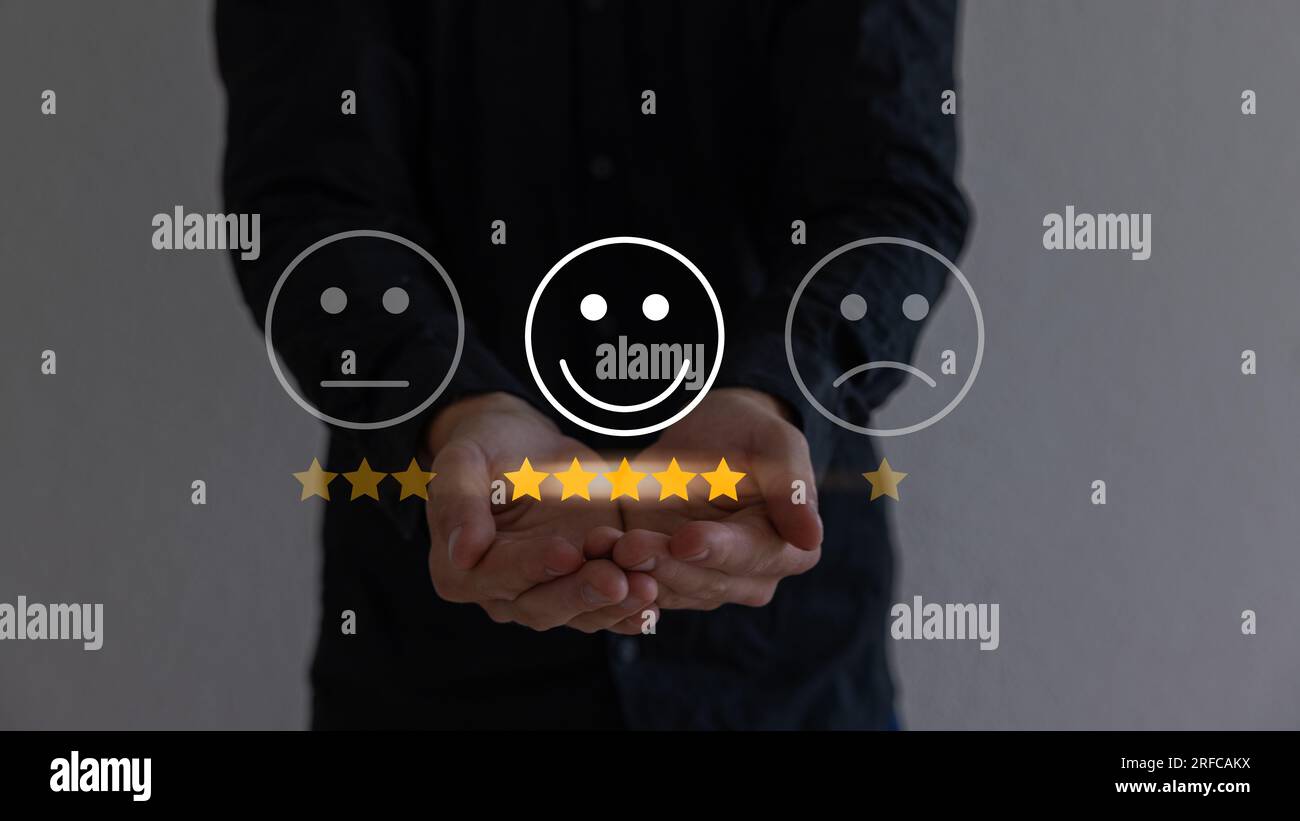 Hand touching and doing mark to select smiley face icon for evaluate ...