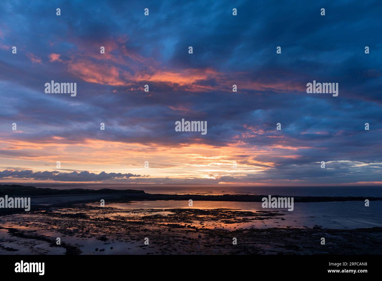 Sunset over Coves Haven Holy Island Stock Photo - Alamy