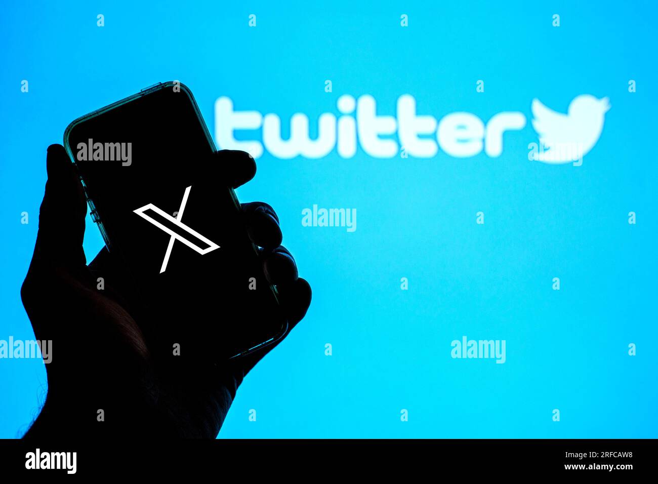 In this photo illustration a new Twitter logo is seen displayed on a ...