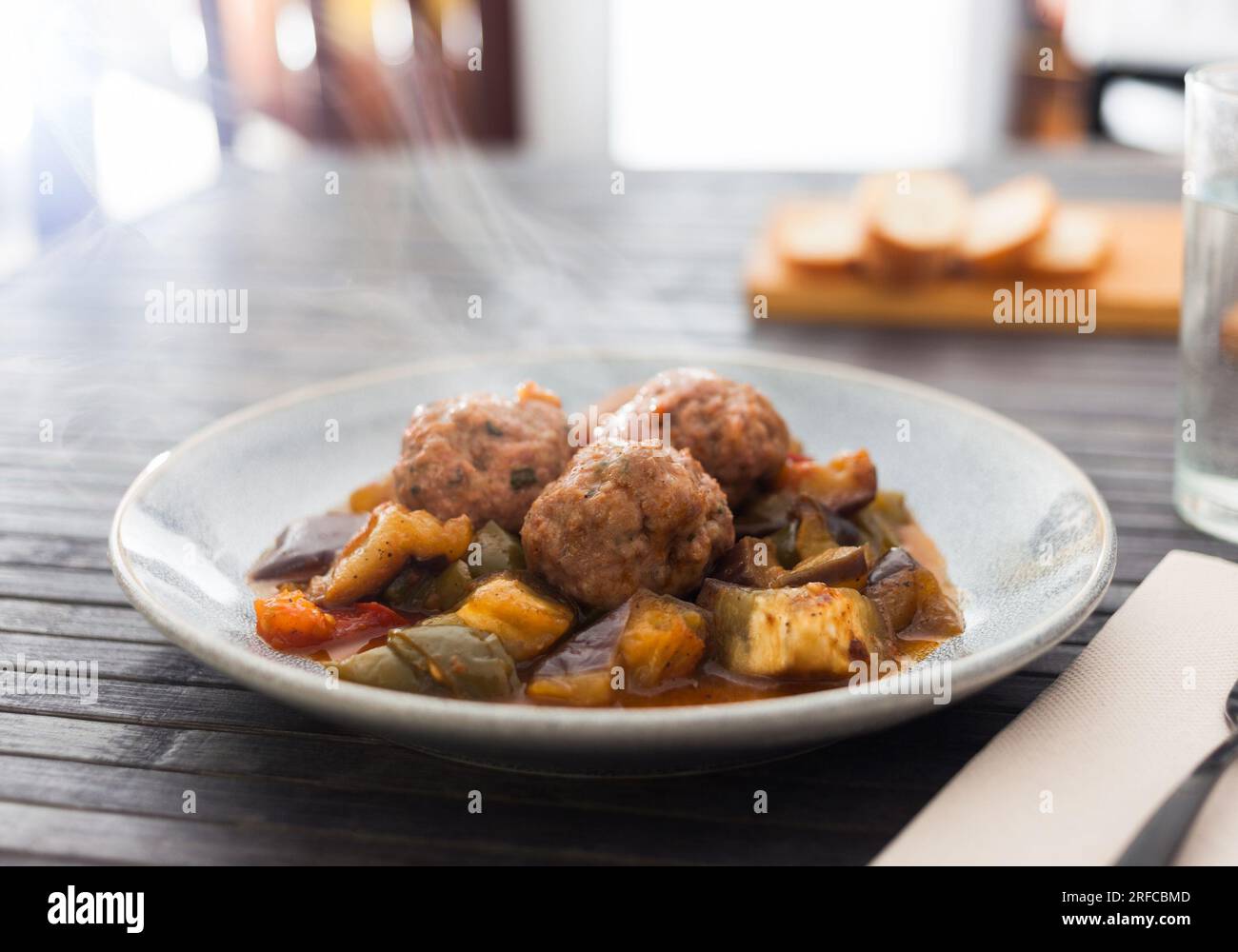 Steamed meatballs with stewed vegetables with haze on plate Stock Photo ...