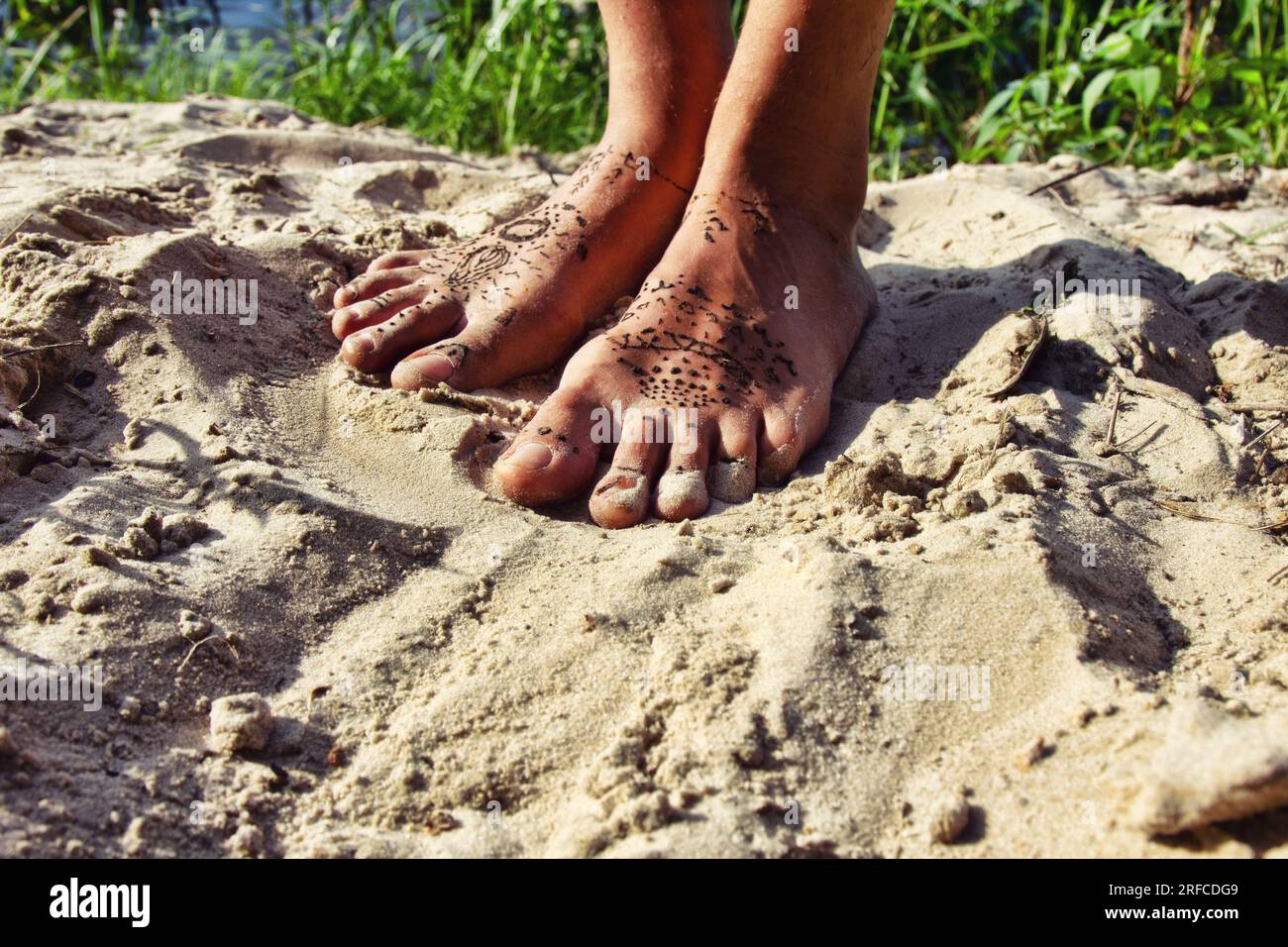 The legs (feet) of follower of Hinduism are painted on a traditional ...