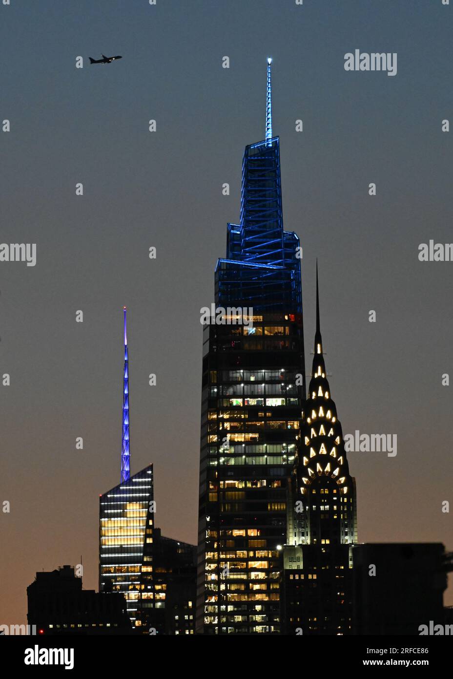 The sun sets behind spires of the Bank of America Tower, One Vanderbilt ...