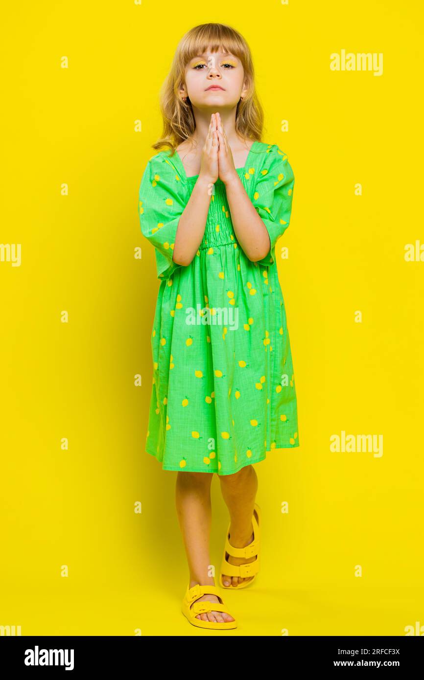 Please, God help. Blonde child girl kid praying, looking at camera ...