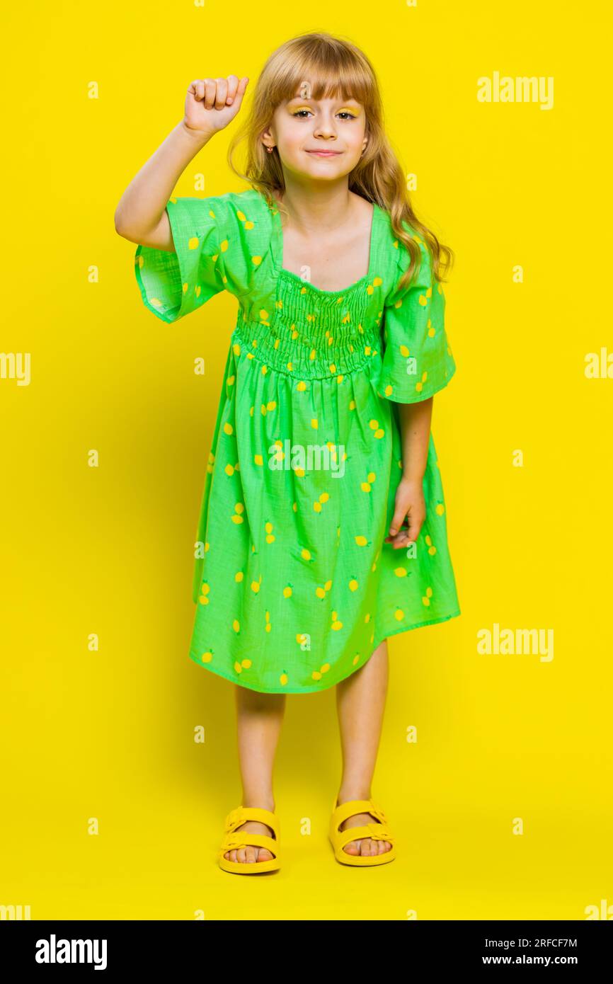 Knock-knock who is there. Confused young blonde child girl kid knocking ...