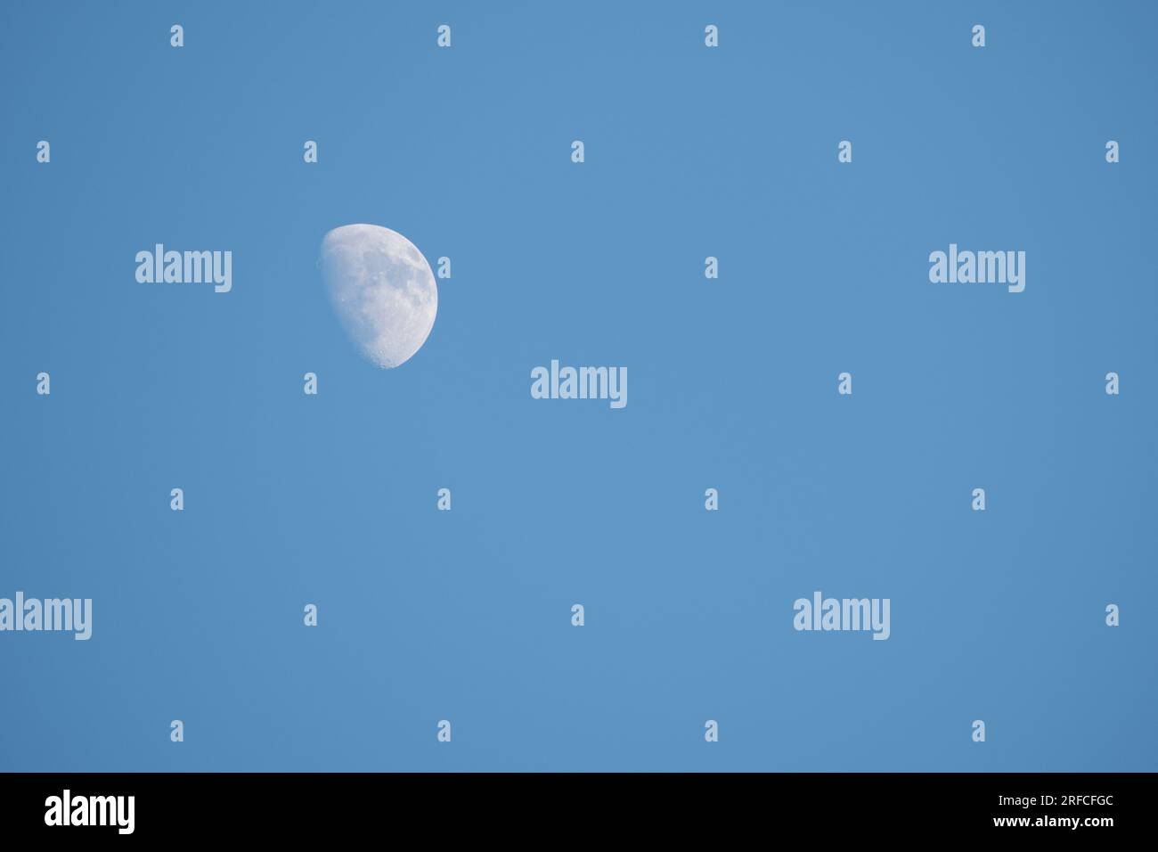 Half moon in daytime sky Stock Photo - Alamy