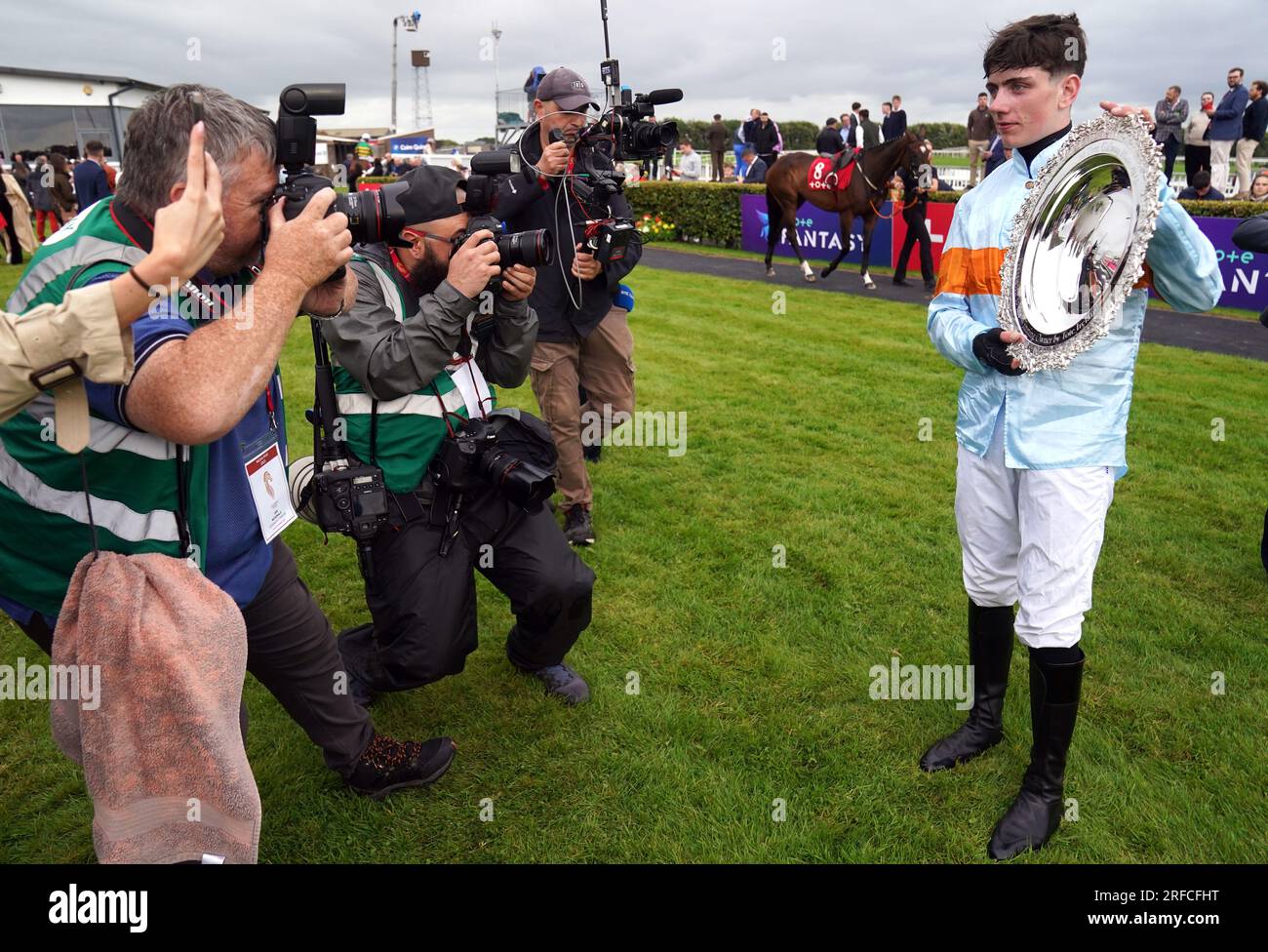 Photographers take photos of jockey Danny Gilligan with the plate after ...