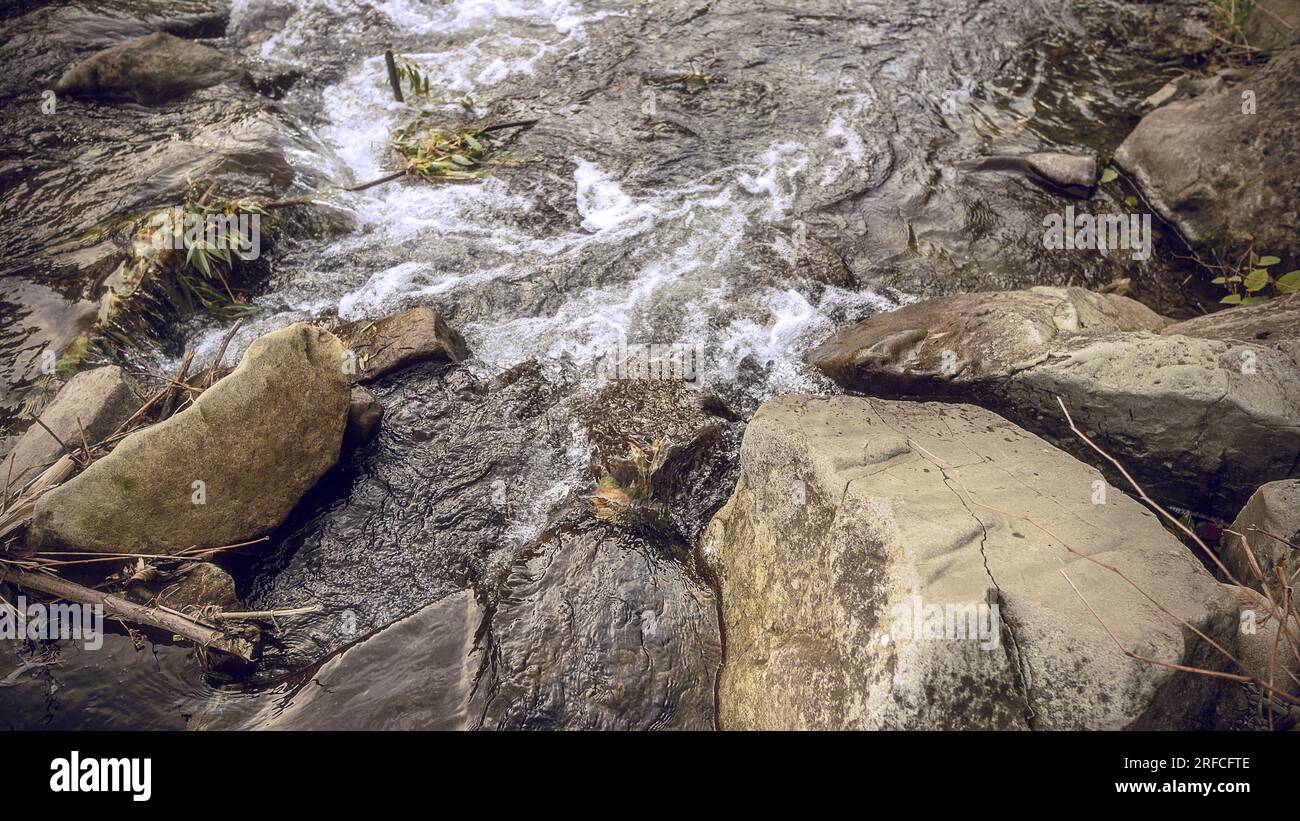 Closeup of river and stones. Water in a raging mountain river ...