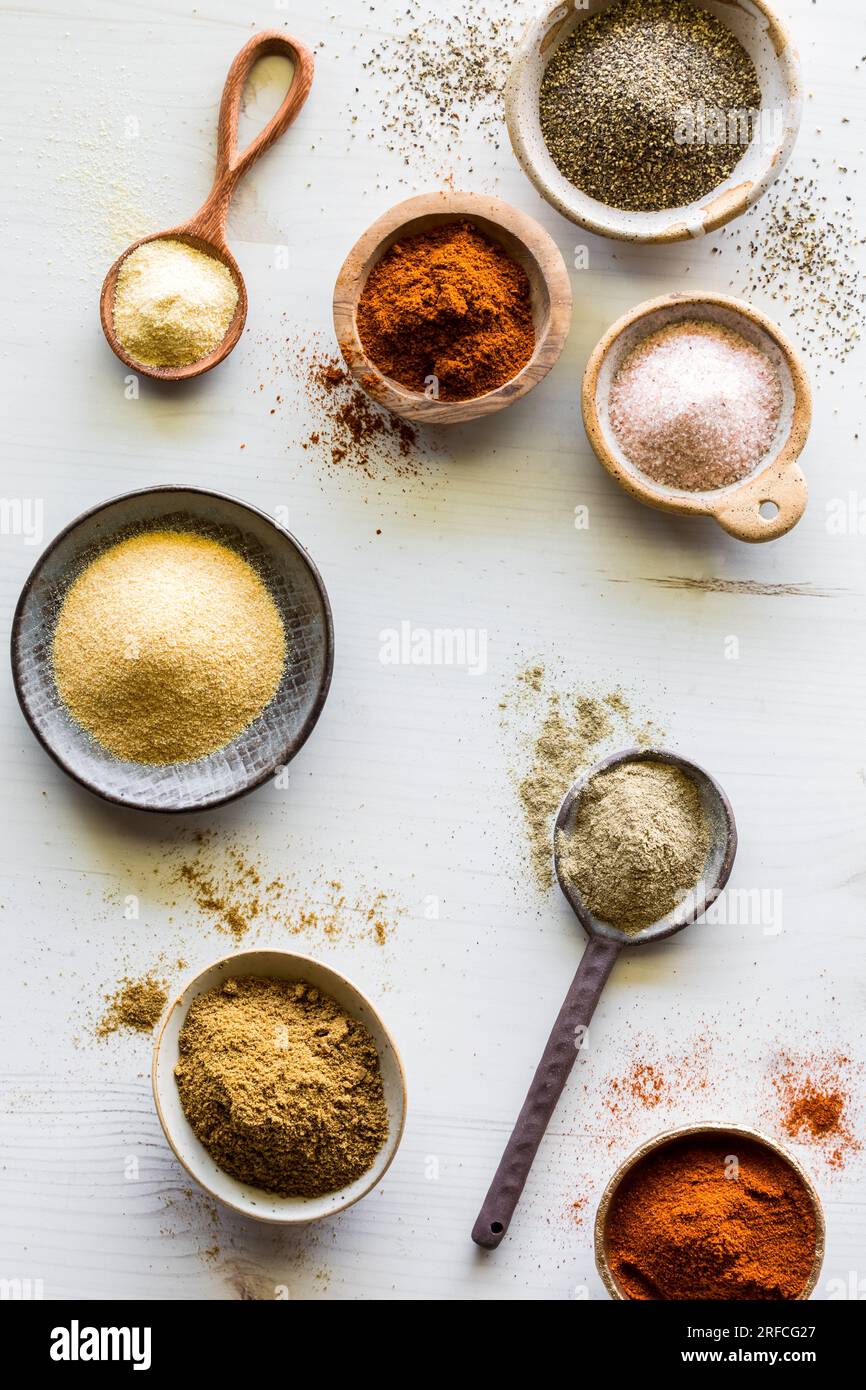 Different sizes of bowls and spoons containing spices to make a taco ...