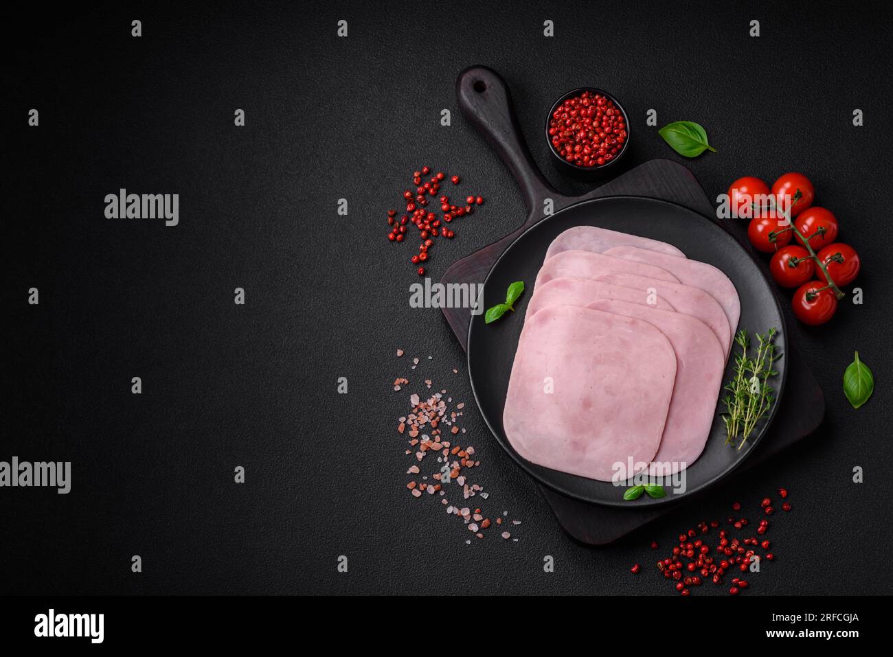 Delicious ham sliced with salt, spices and herbs as ingredients for ...