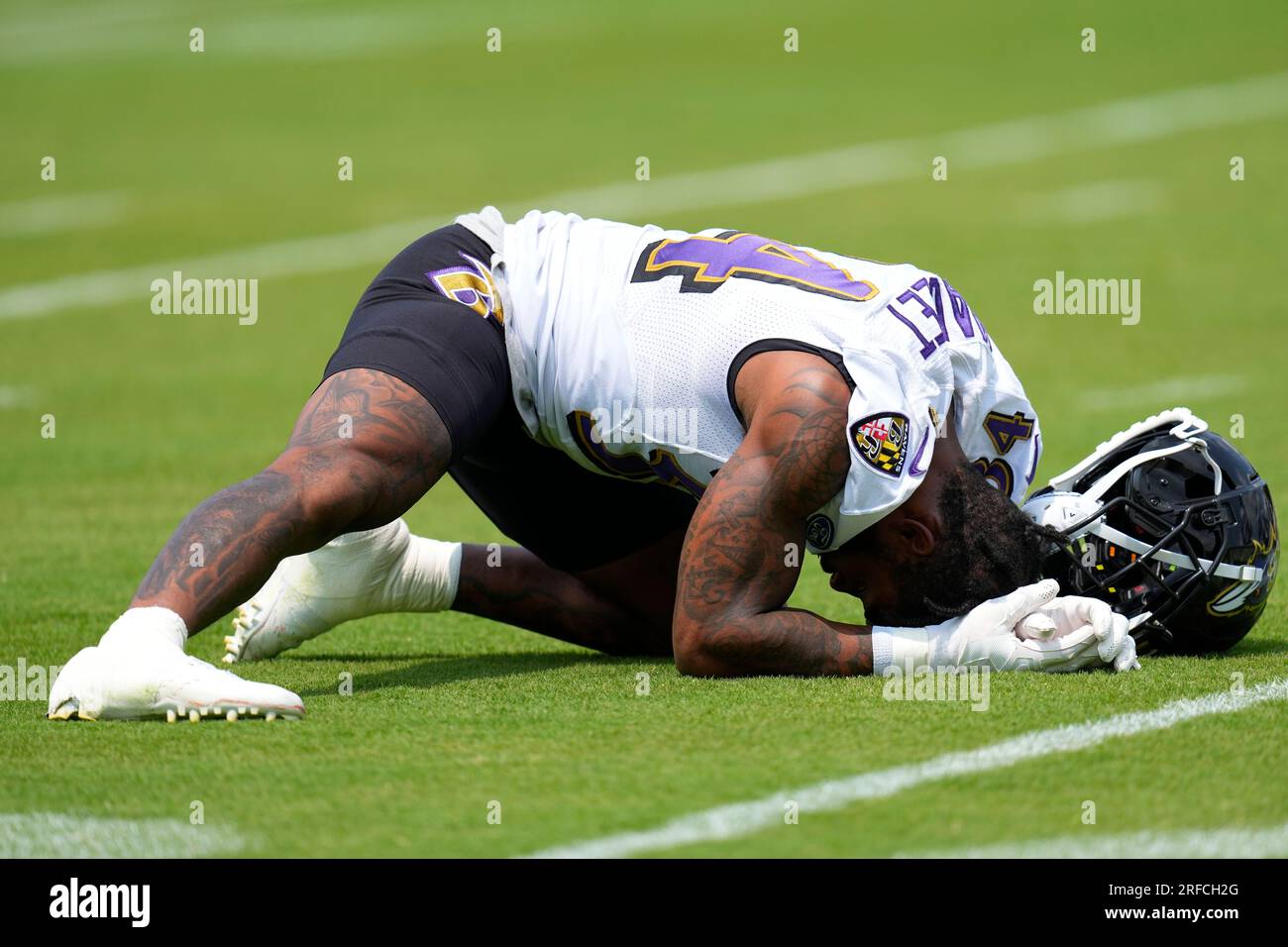 Baltimore Ravens cornerback Arthur Maulet stretches during his team's NFL football training camp ...