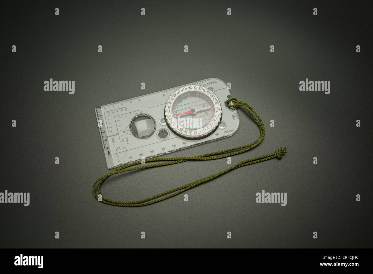 Map readers compass and lanyard on a grey stone background Stock Photo ...