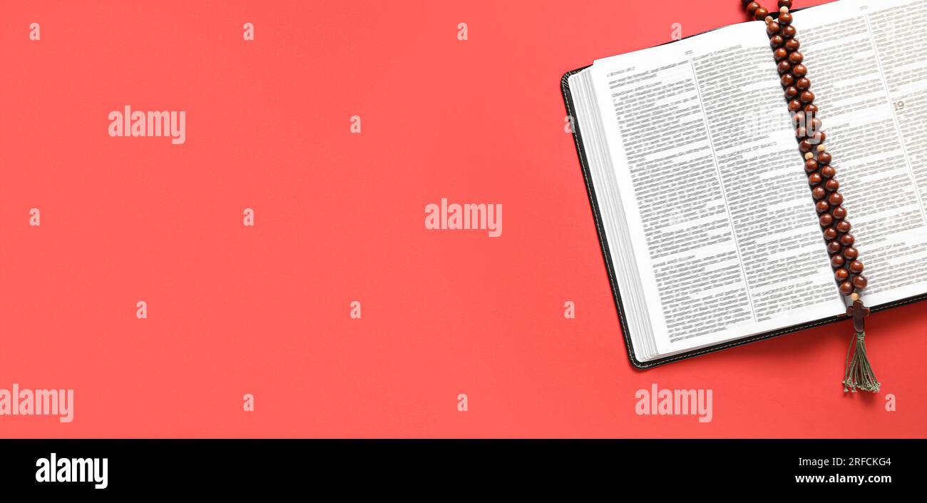 Open Holy Bible and prayer beads on red background with space for text ...