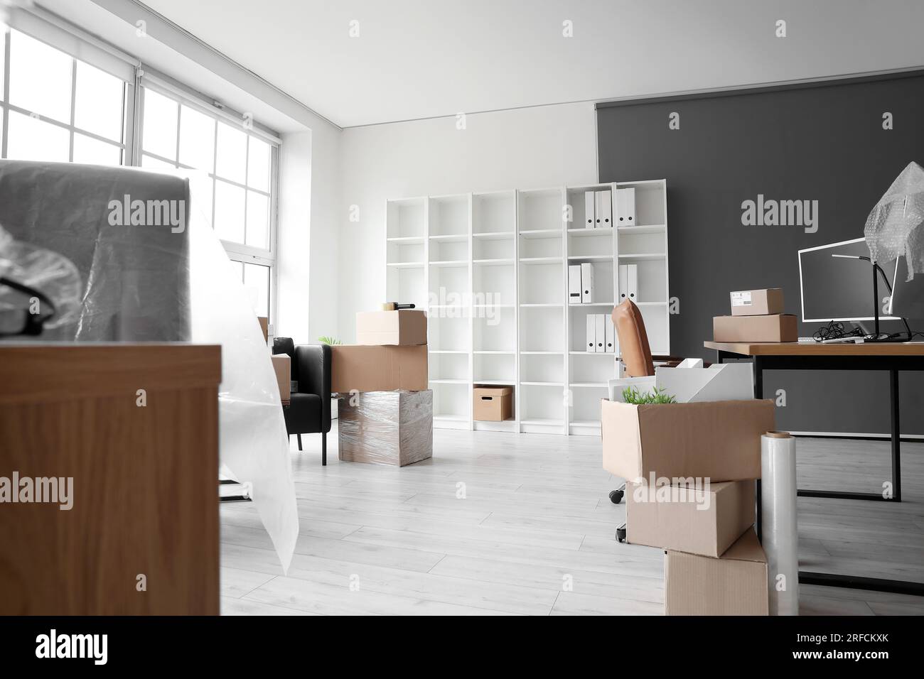 Workplace with cardboard boxes in office on moving day Stock Photo - Alamy