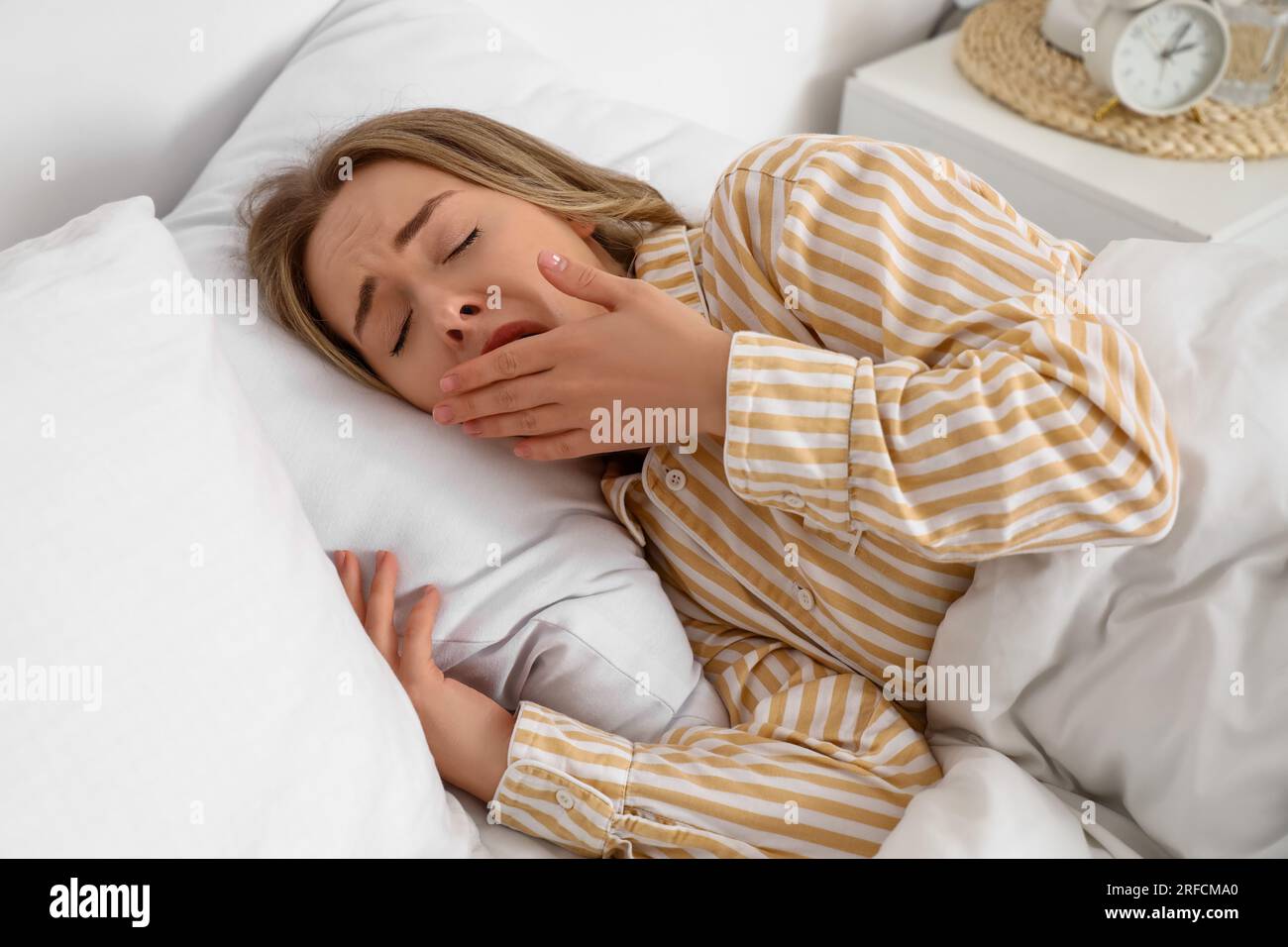 Woman yawning in bed hi-res stock photography and images - Alamy