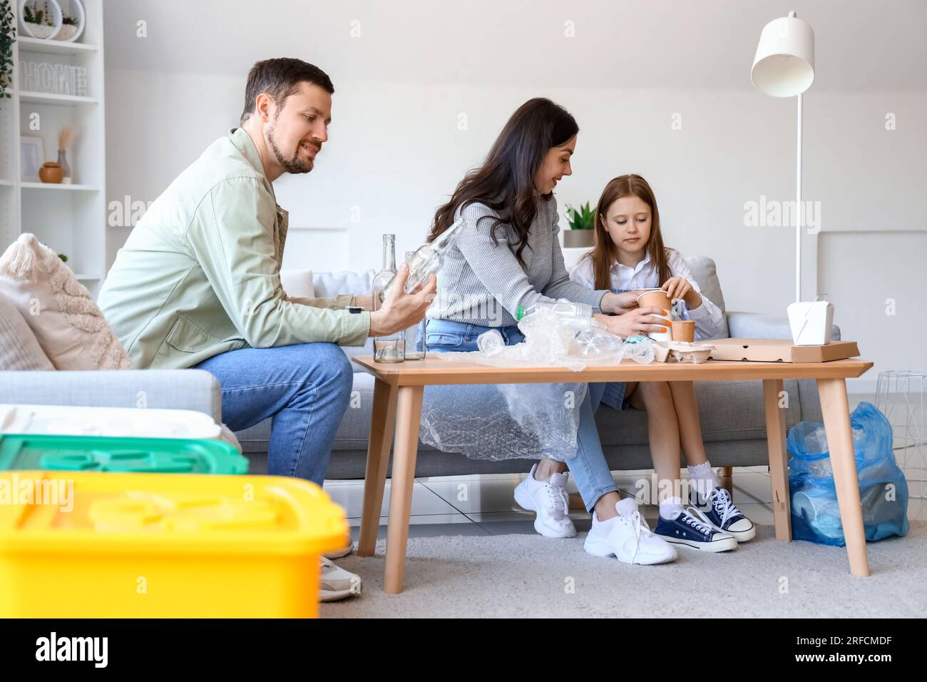 Family sorting garbage at home Stock Photo - Alamy