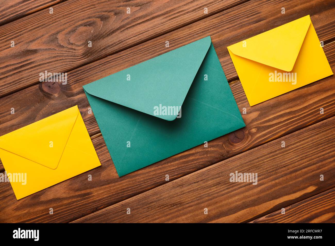 Set of colorful envelopes on wooden background Stock Photo - Alamy