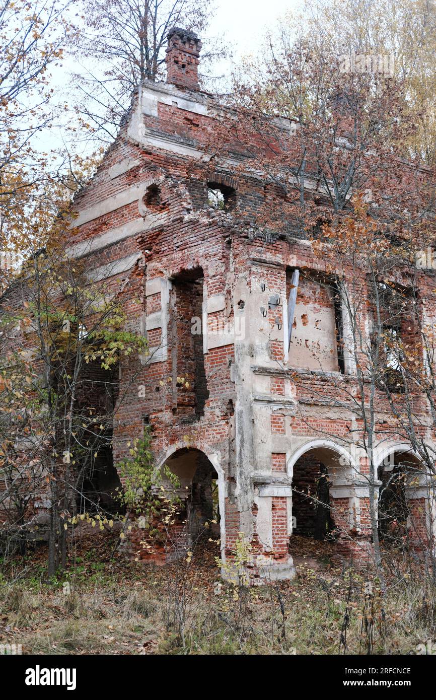 Old ruined brick building with arches in the autumn forest. Building ...