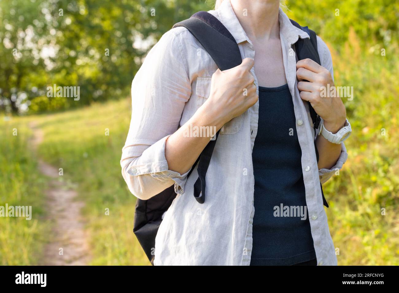 Woman holding her backpack hi-res stock photography and images - Alamy
