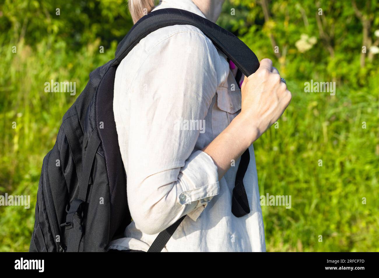 Woman holding her backpack hi-res stock photography and images - Alamy