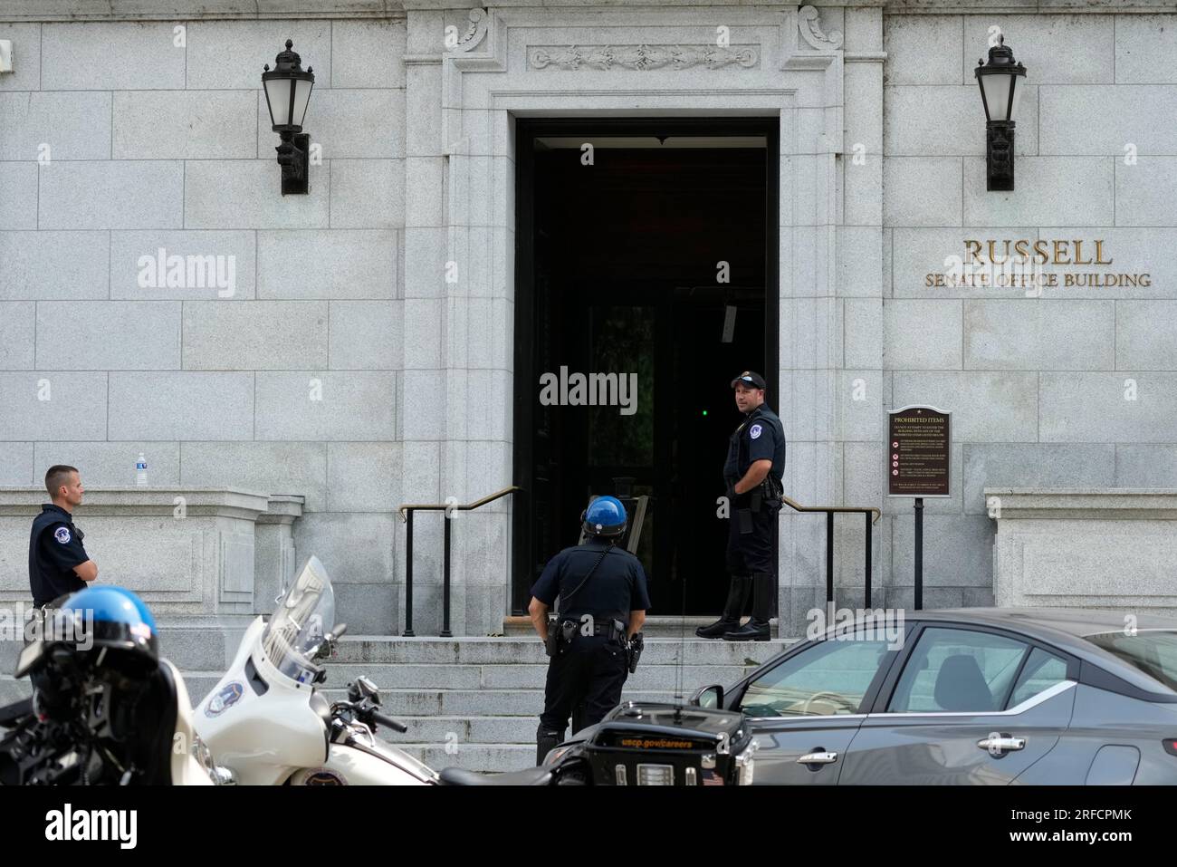 U.S. Capitol Police officers watch a doorway into the Russell Senate ...