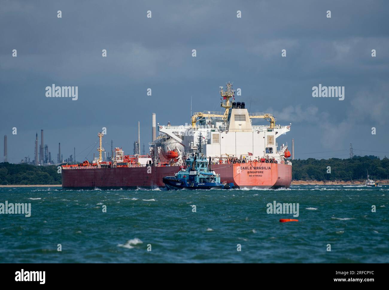 large crude oil tanker ship in the thorn channel with a tug in the ...