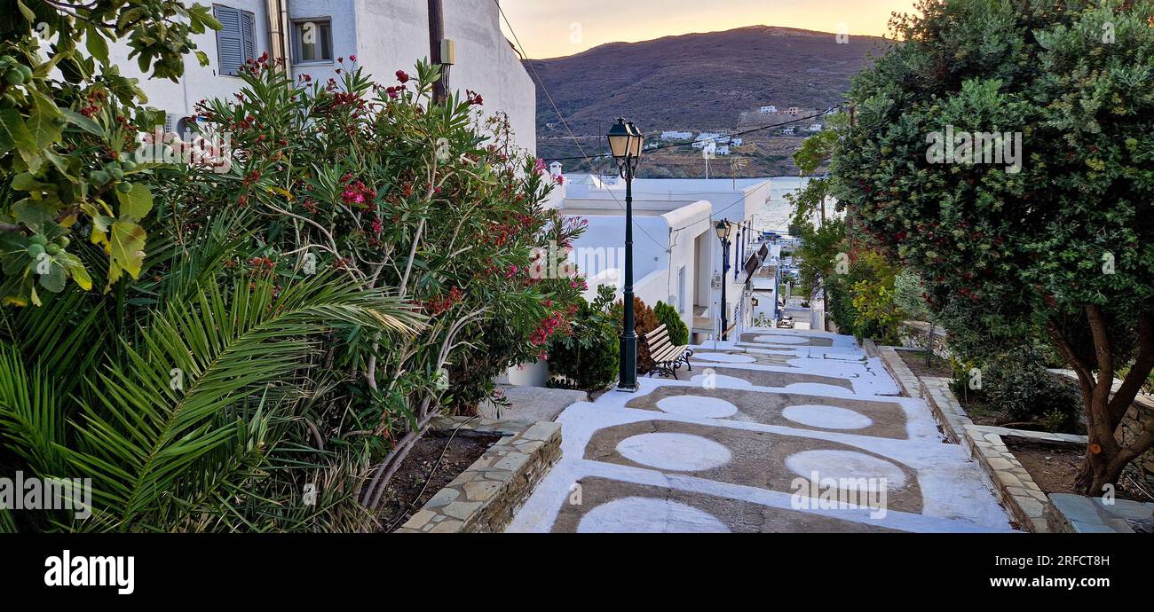 Empty pedestrian street at sunset, Gavrio, Andros island, Greece ...