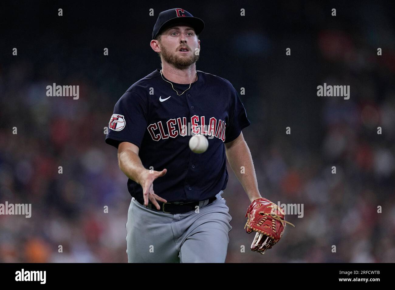 Cleveland Guardians starting pitcher Tanner Bibee tosses a comebacker ...