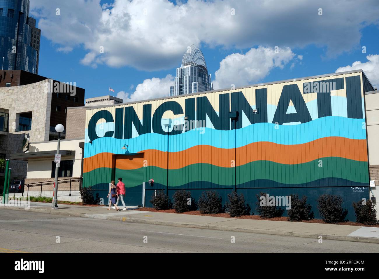 Pedestrians walk in front of a mural on the outside of The Filson Queen ...