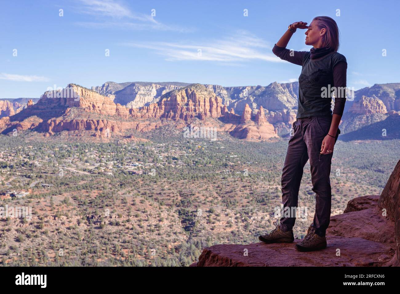 A woman enjoys the expansive views over the valley below overlooking ...