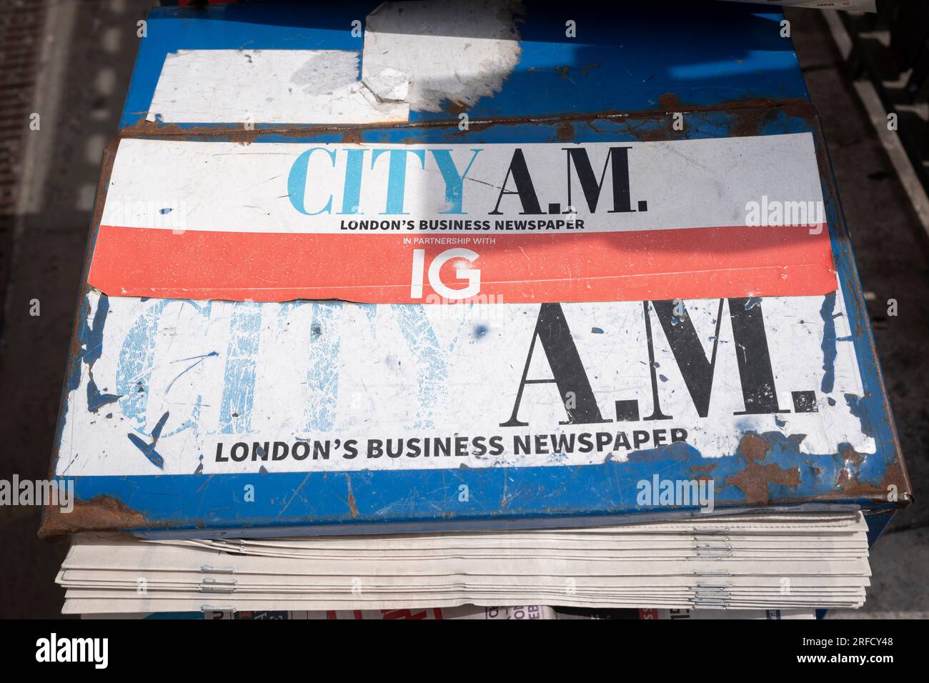 A detail of a metal vendor stand containing copies of the 'City AM ...