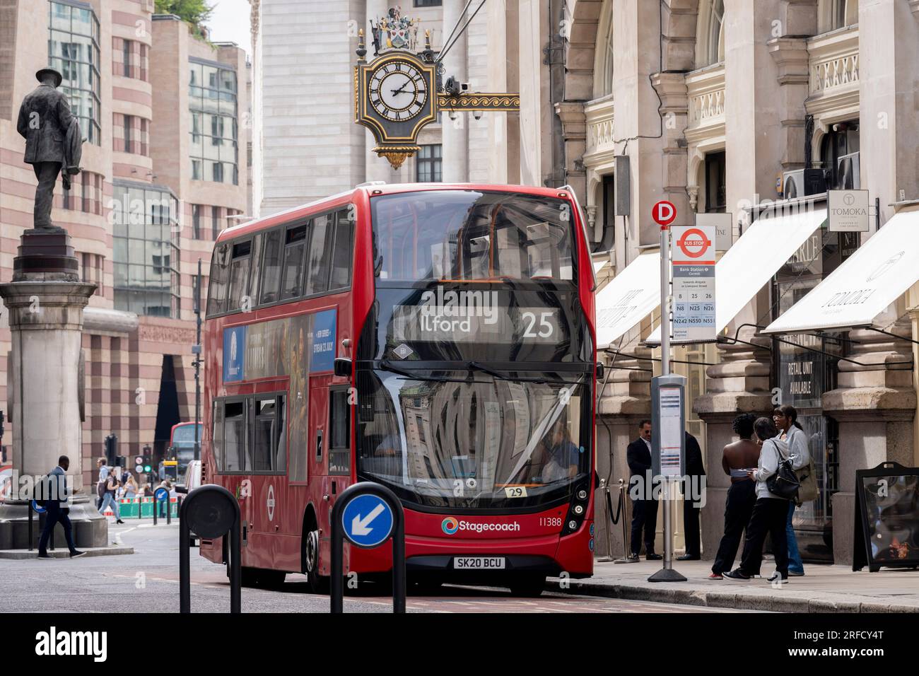 A view up Cornhill where a number 25 bus has paused its journey near ...