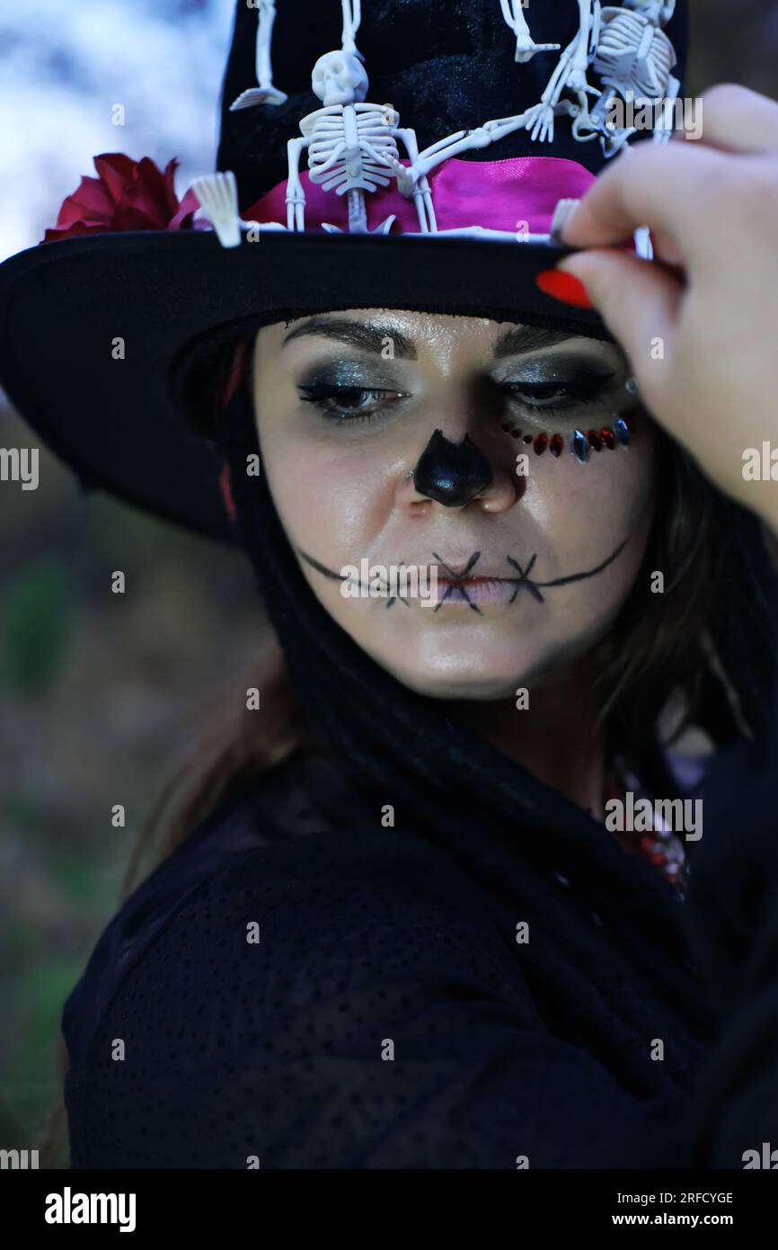 A woman dressed as Baron Saturday poses for the camera. The model is ...