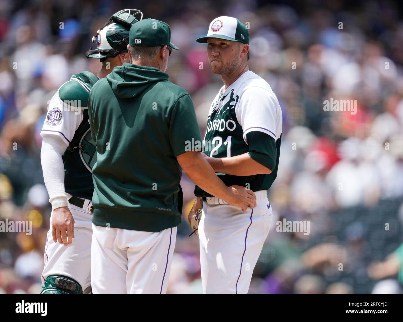 Colorado Rockies pitching coach Darryl Scott, front, confers with ...