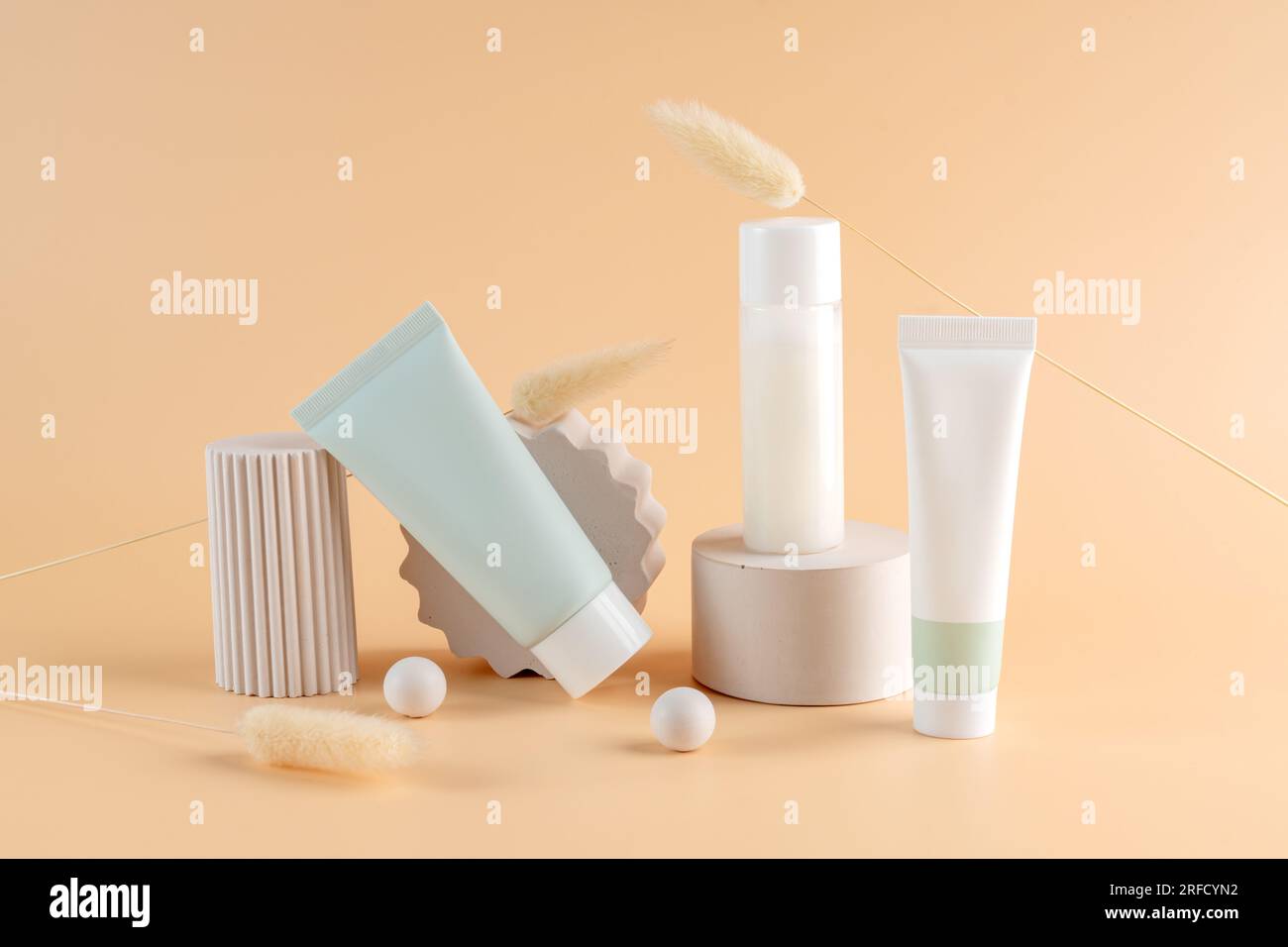 Group of white and green blank, unbranded cosmetic cream jars and tubes ...