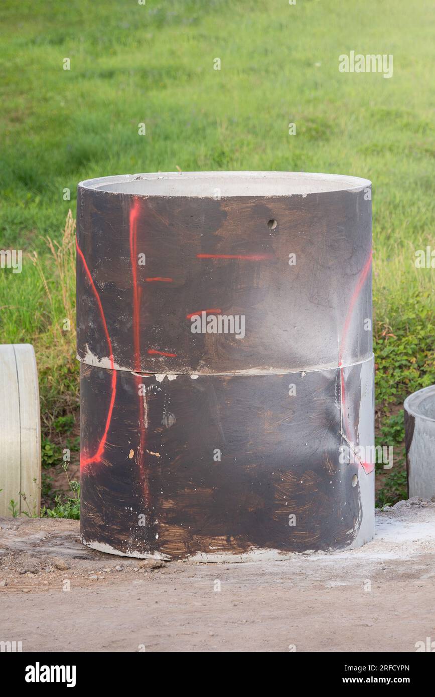 Concrete pipes on the side of the reconstructed road. Large concrete ...