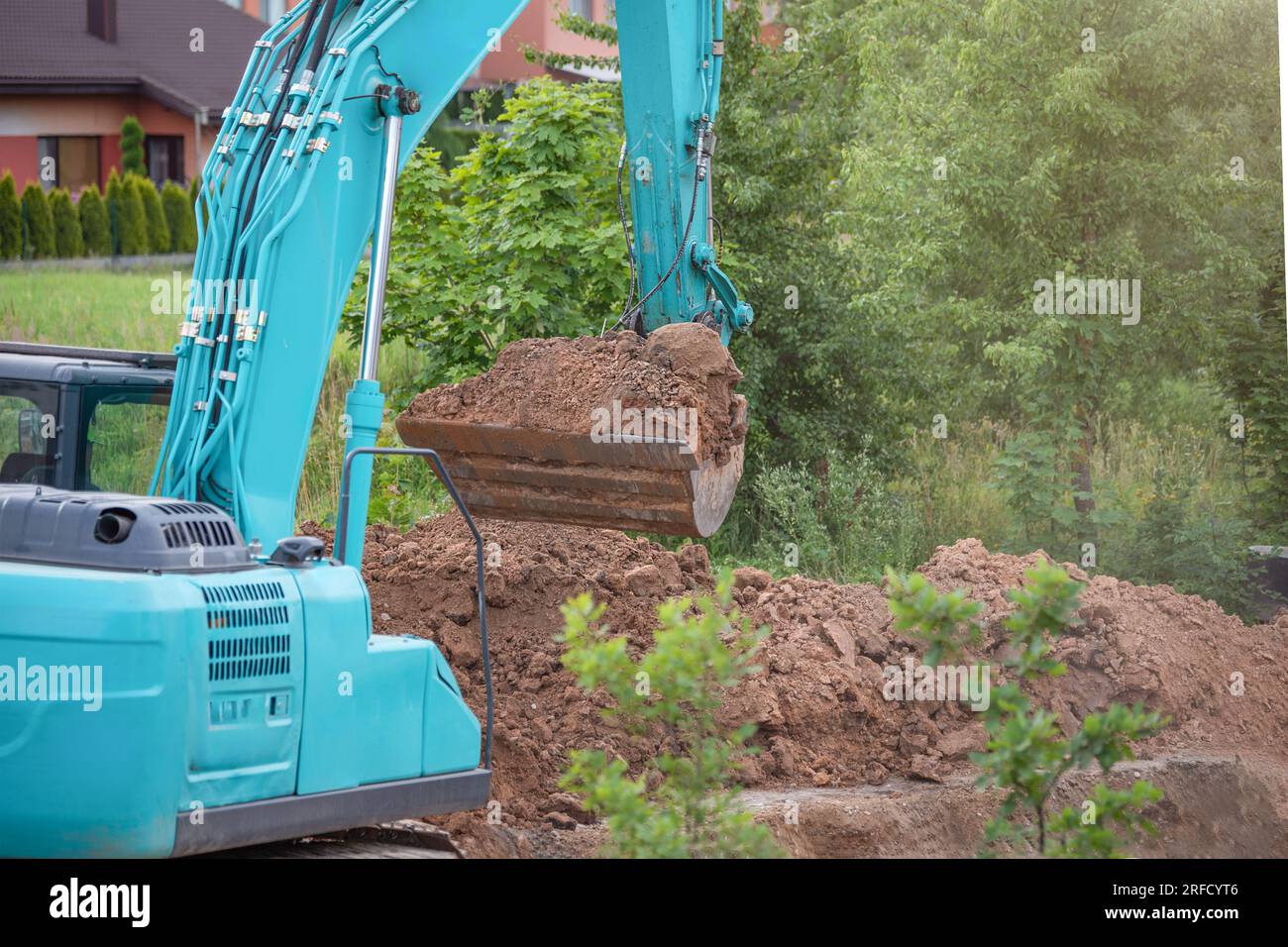 The process of working heavy construction equipment. A big blue ...