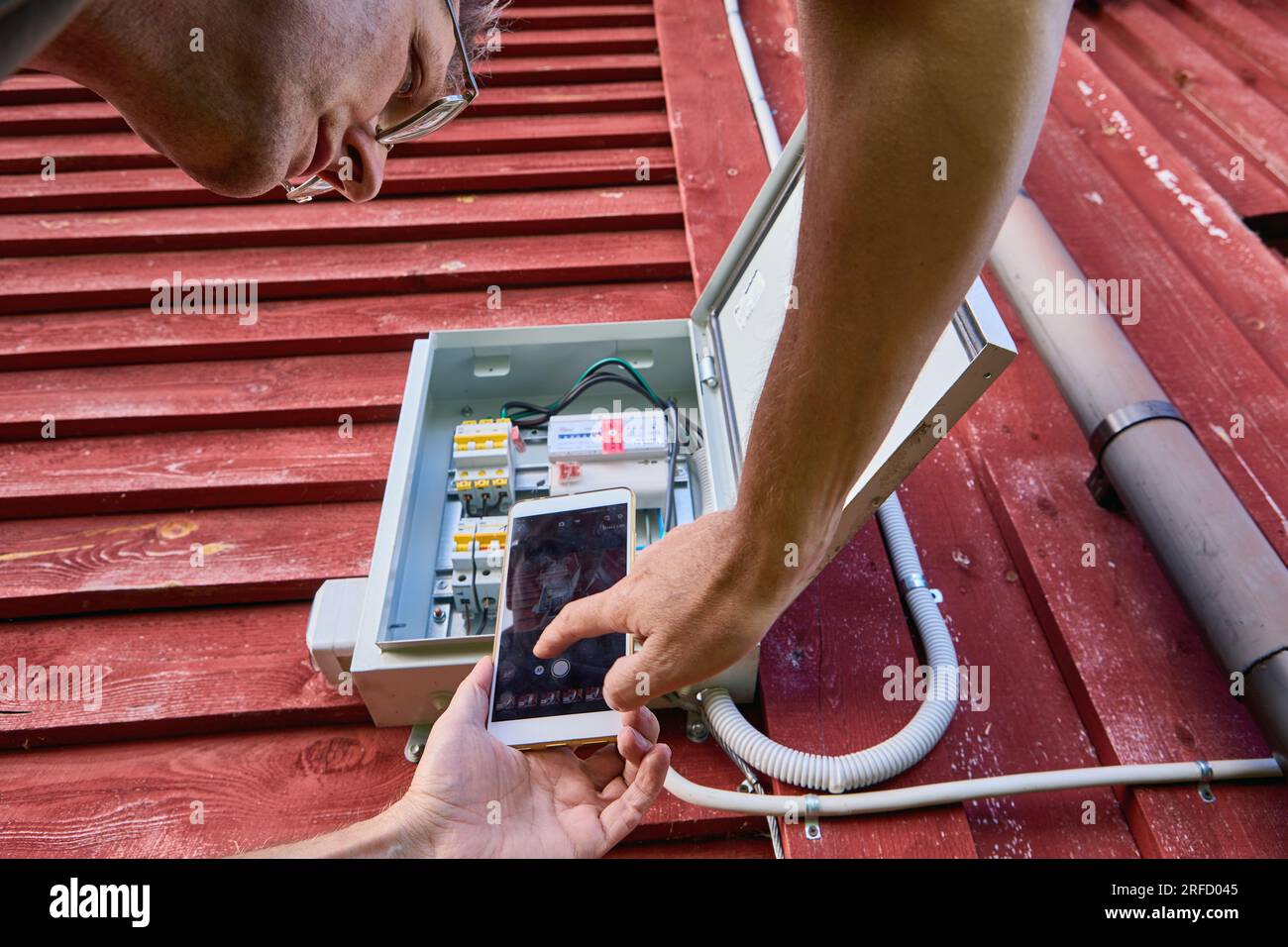 Taking readings from an electric meter located outdoors, using ...