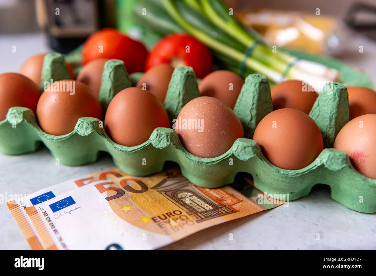 A cost of living, food inflation concept with Euro bank notes under a ...