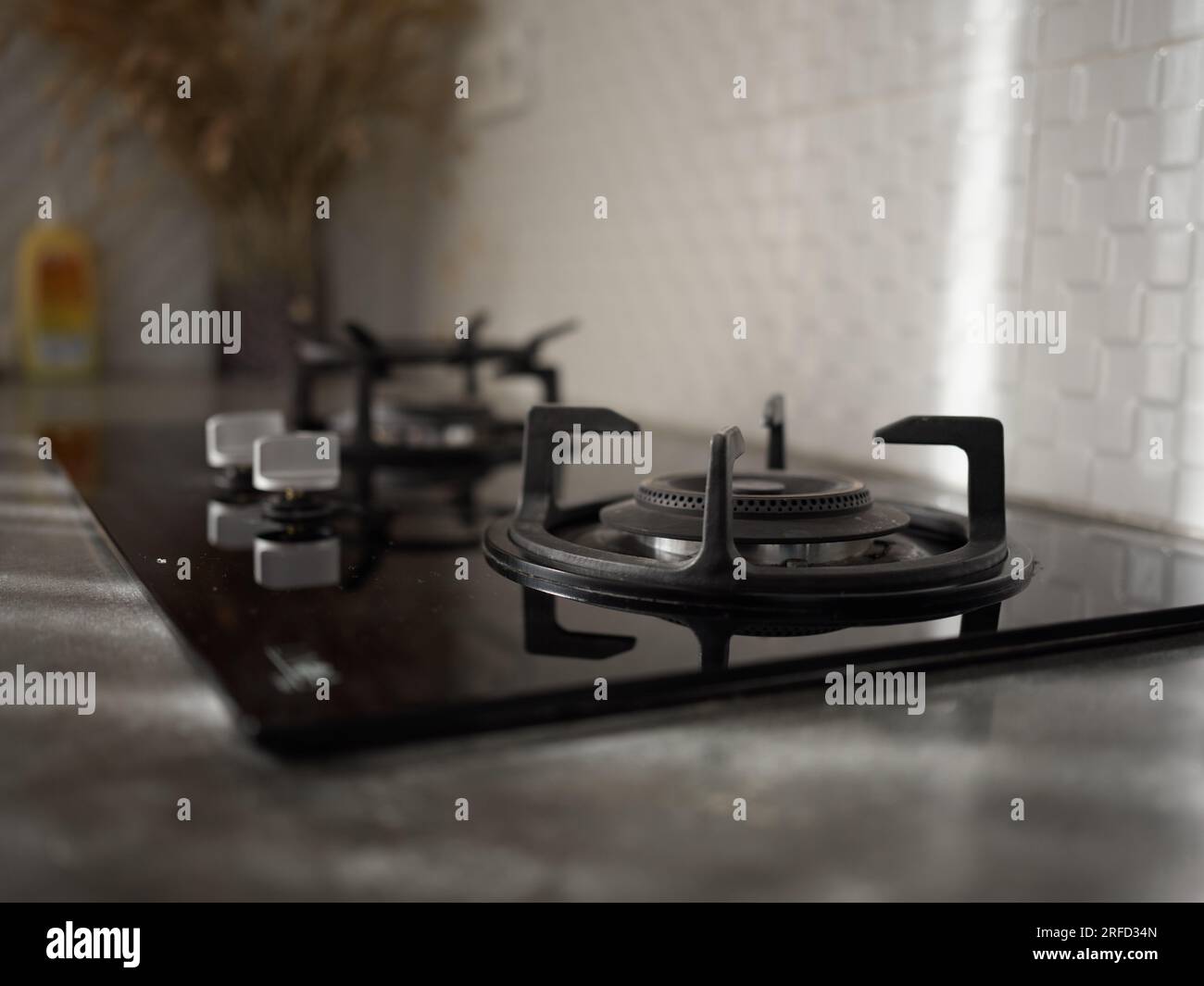 Modern gas stove built into a black table in the kitchen Stock Photo ...